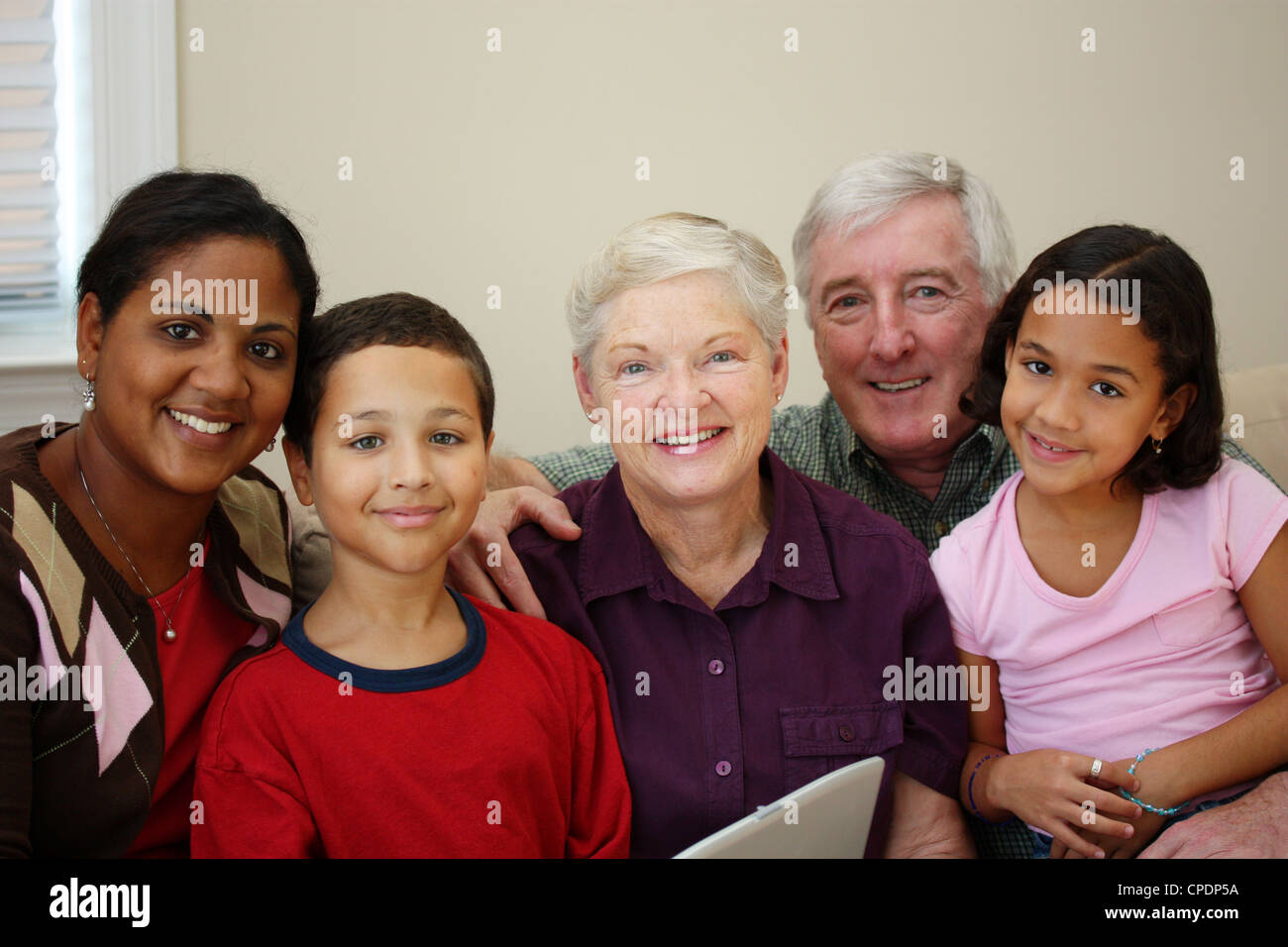 Grandparents together with their family at home Stock Photo - Alamy