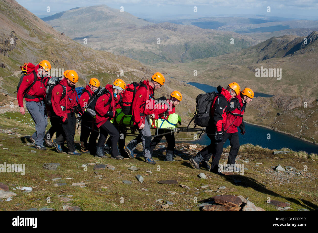 Mountain Rescue Team Members Move Stretcher With Casualty To Await Mountain Rescue Team Members Move Stretcher With Casualty To Await