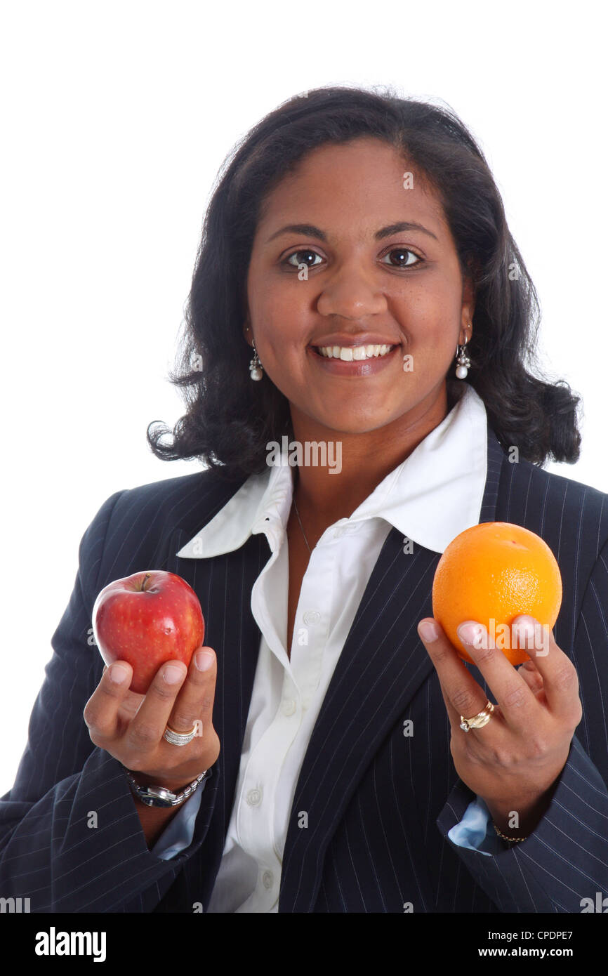 Woman comparing apples and oranges on a white background Stock Photo ...