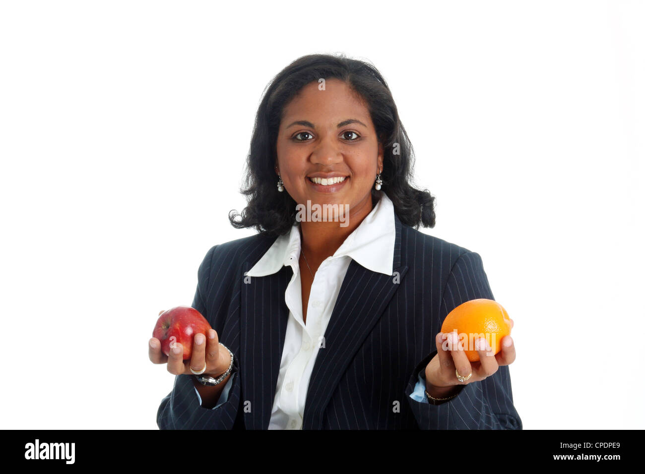 Woman comparing apples and oranges on a white background Stock Photo ...