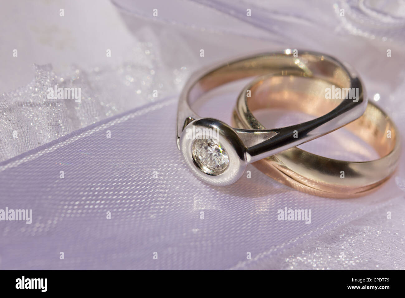 engagement rings on white lace abstract background Stock Photo - Alamy