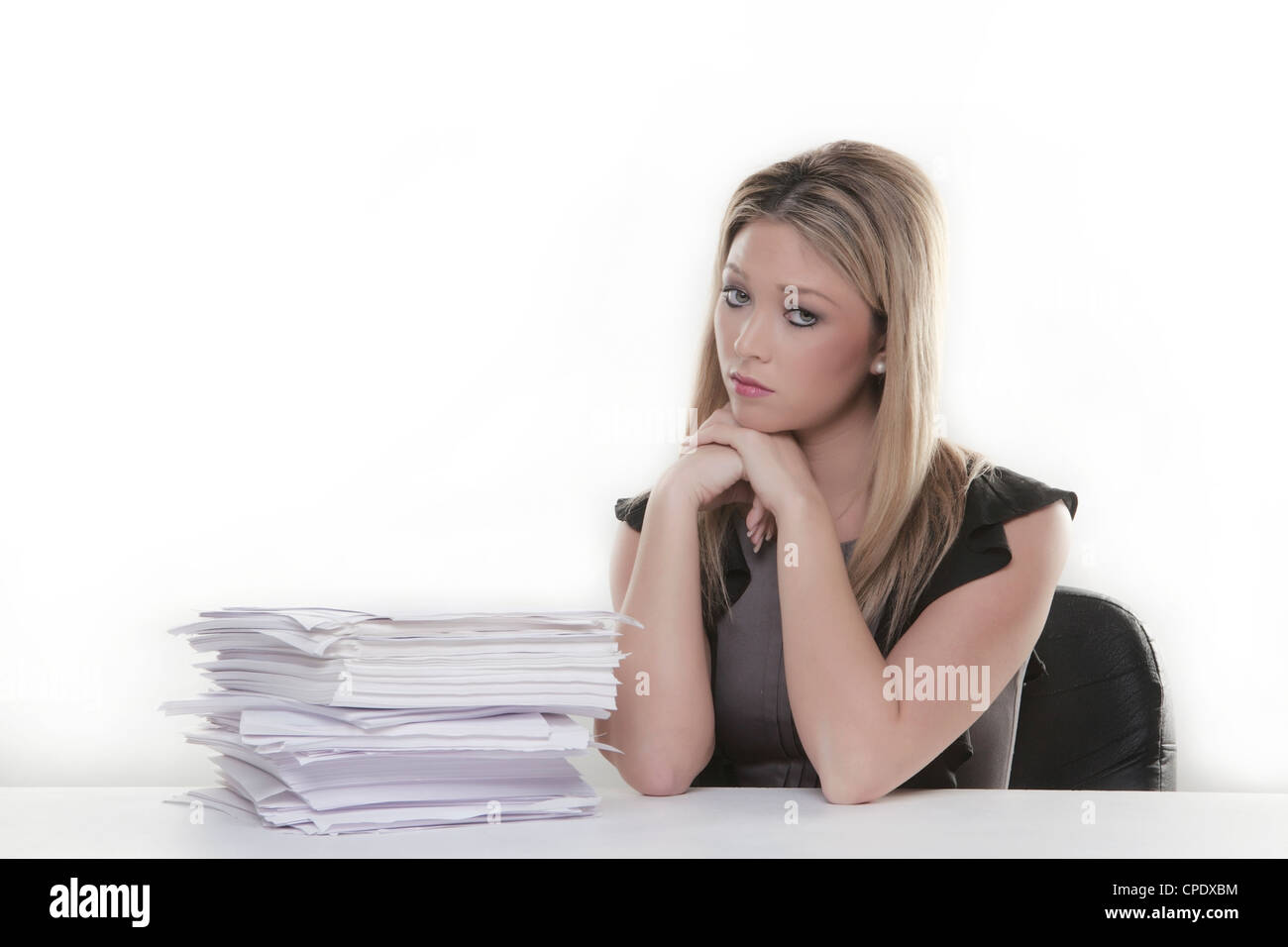 attractive woman at her desk with a lot of paper work to do Stock Photo ...