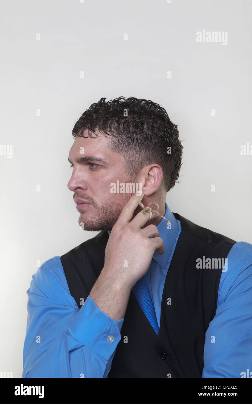 handsome business man with a piece of string tied round his finger so ...