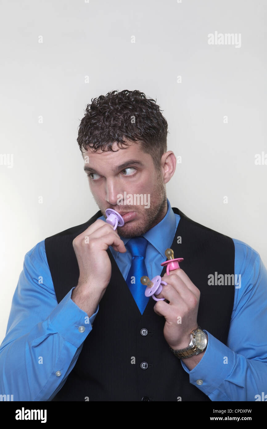 handsome man with a baby dummy in his mouth looking silly Stock Photo ...