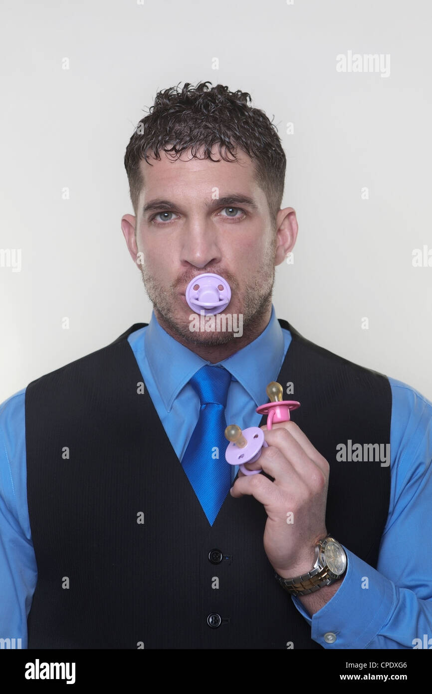 handsome man with a baby dummy in his mouth looking silly Stock Photo ...