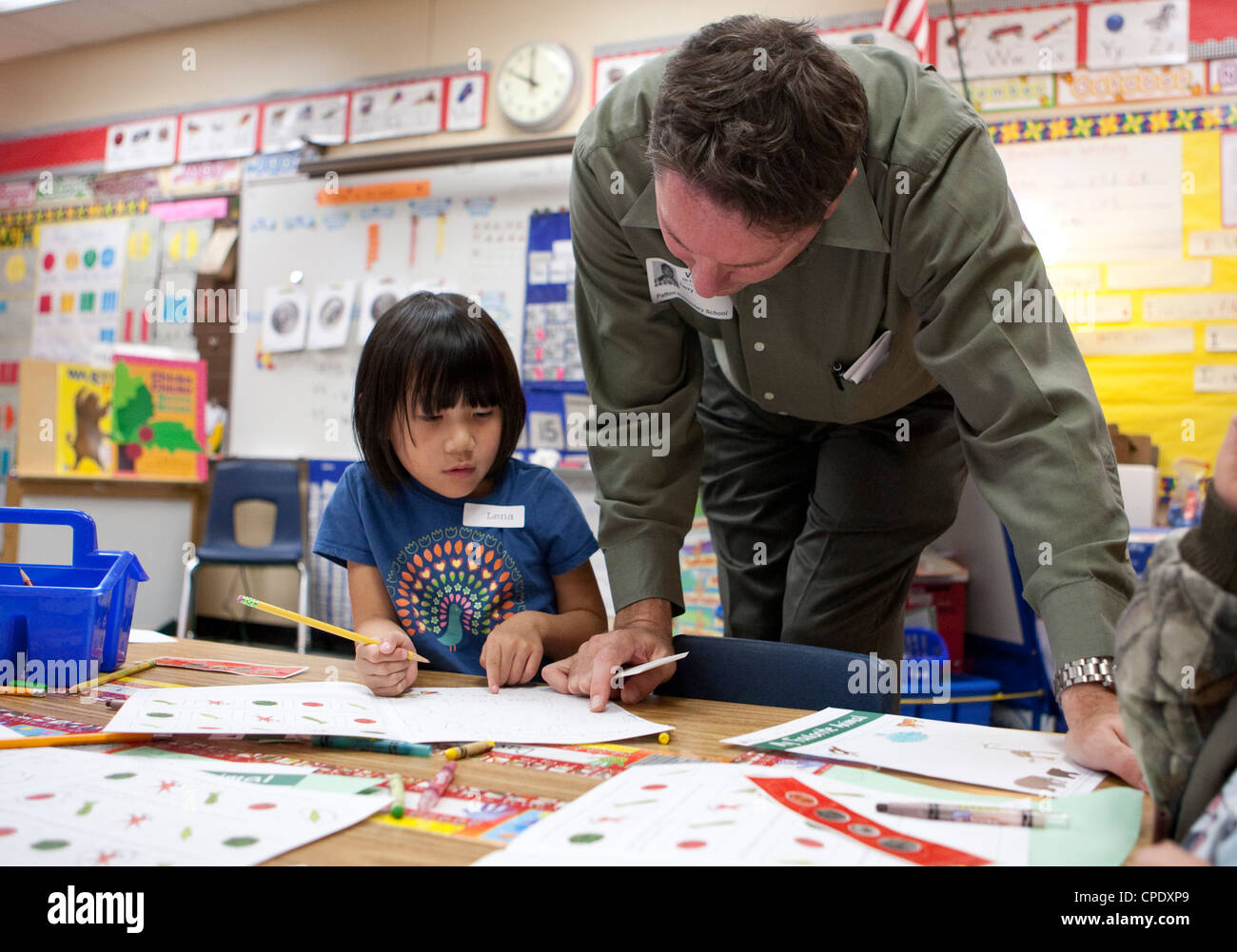 Anglo male teacher in training, interacts with multi-ethnic group of ...