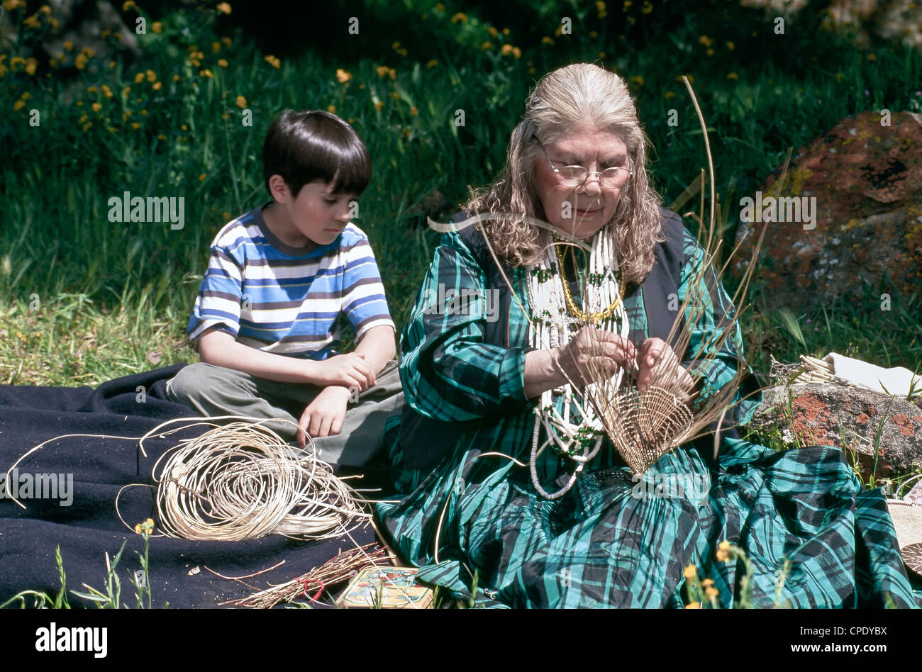 Kashia Pomo woman weaving 'cone shaped acorn gathering basket, grandson ...
