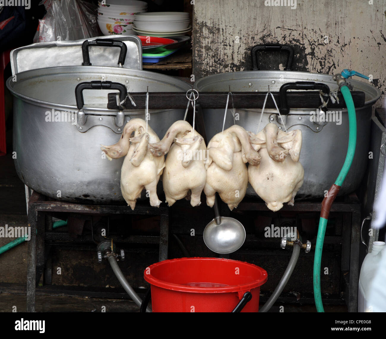 Boiled chickens hanging Stock Photo - Alamy