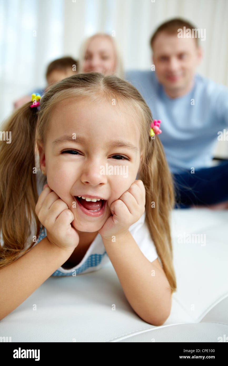 Portrait of a cute girl on bed looking at camera Stock Photo - Alamy