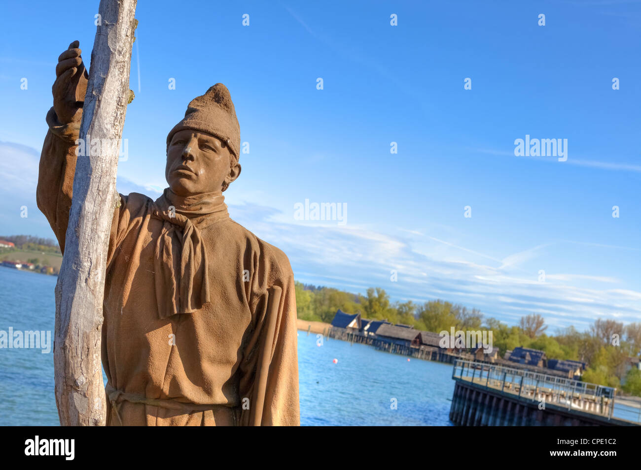 Sculpture of a pile maker in Unteruhldingen pier, stilt houses in the ...