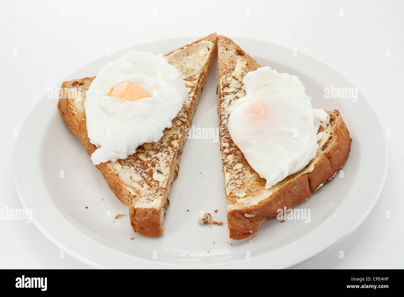 Two poached eggs on toast triangles Stock Photo - Alamy