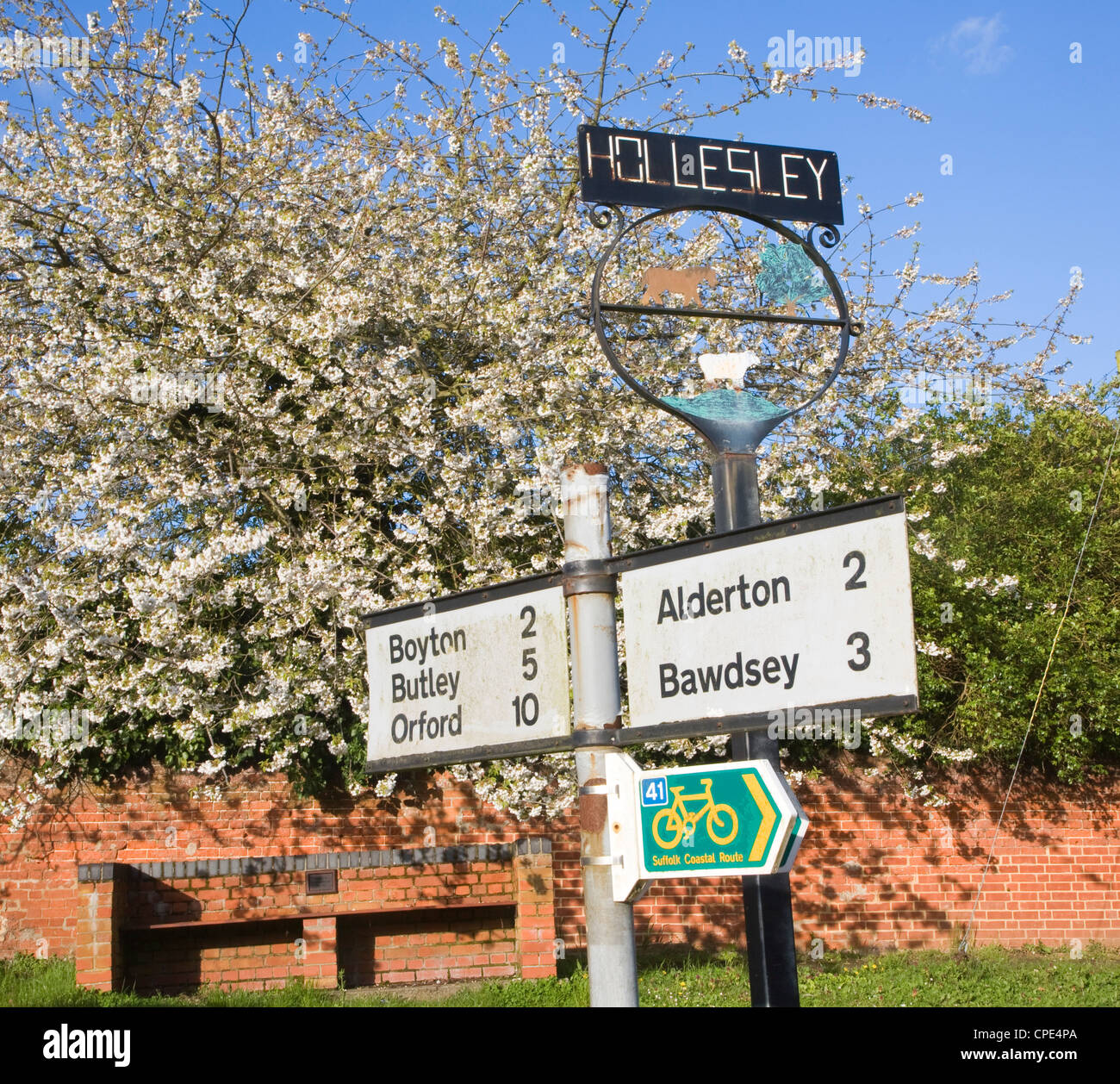 Village signpost distance miles spring blossom Hollesley, Suffolk ...
