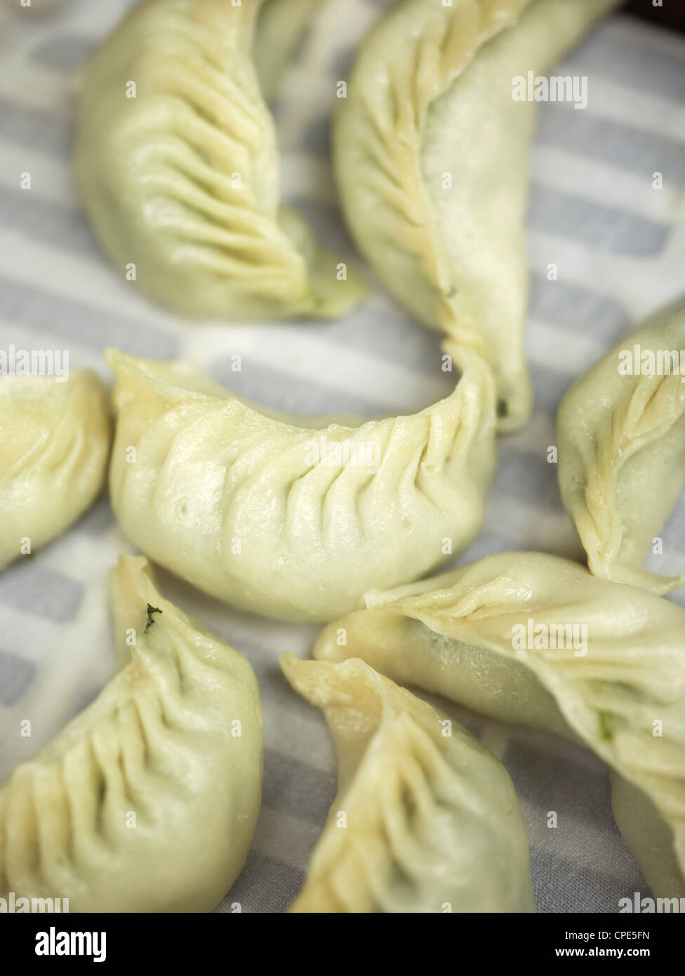 Dumplings, a traditional Chinese delicacy, being prepared by a street ...
