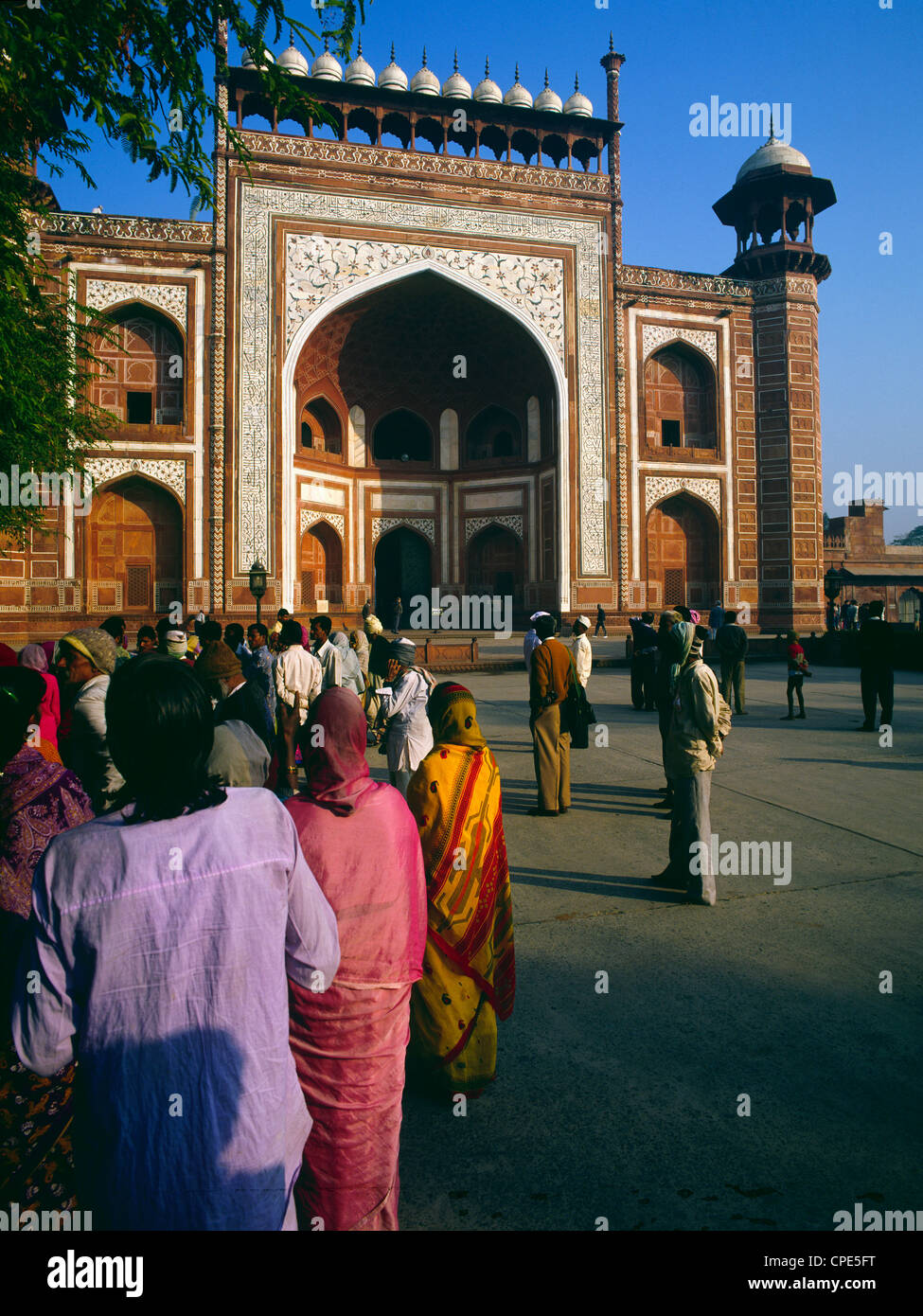 Early morning in front of the massive entrance gate to the Taj Mahal ...