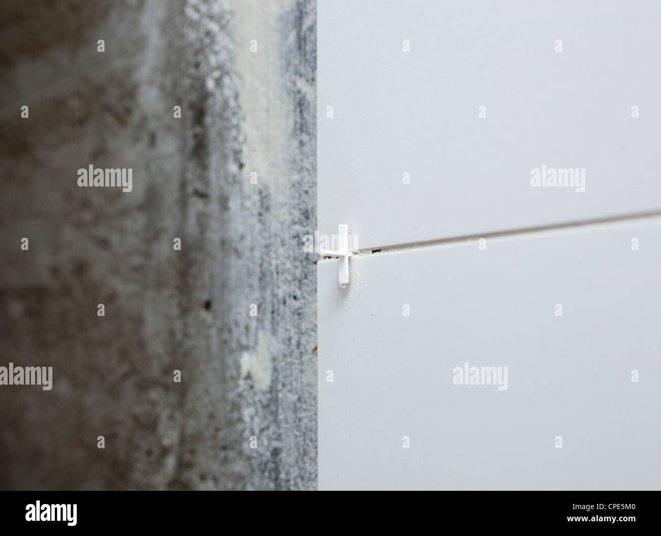 construction work detail of ceramic tile spacers cross Stock Photo - Alamy
