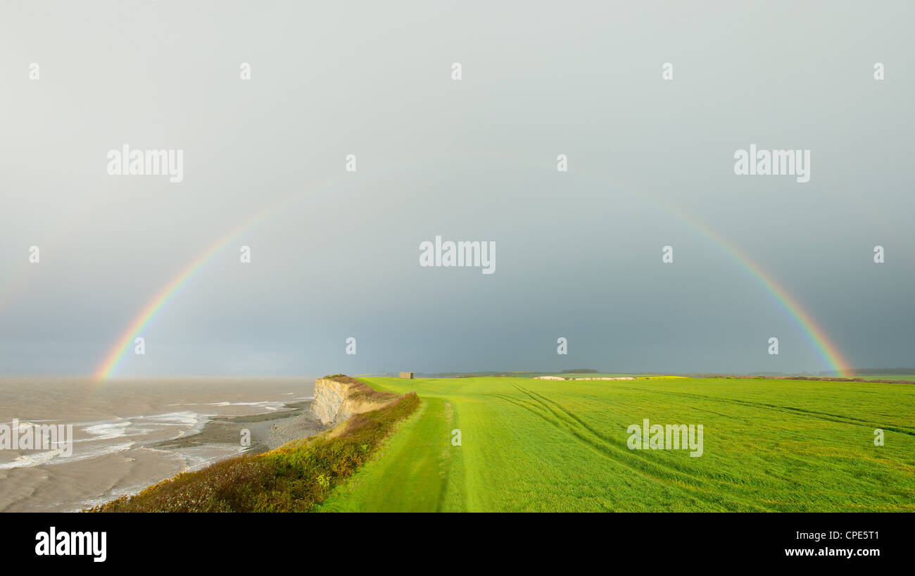 Complete Rainbow on the coast Stock Photo - Alamy