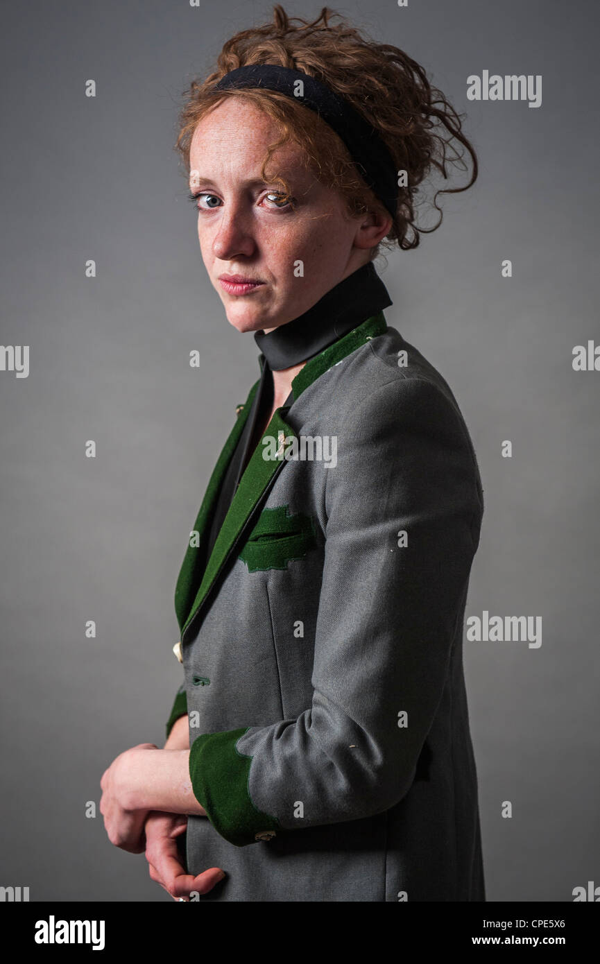 A slim 'alternative' woman wearing a jacket and black headband ...