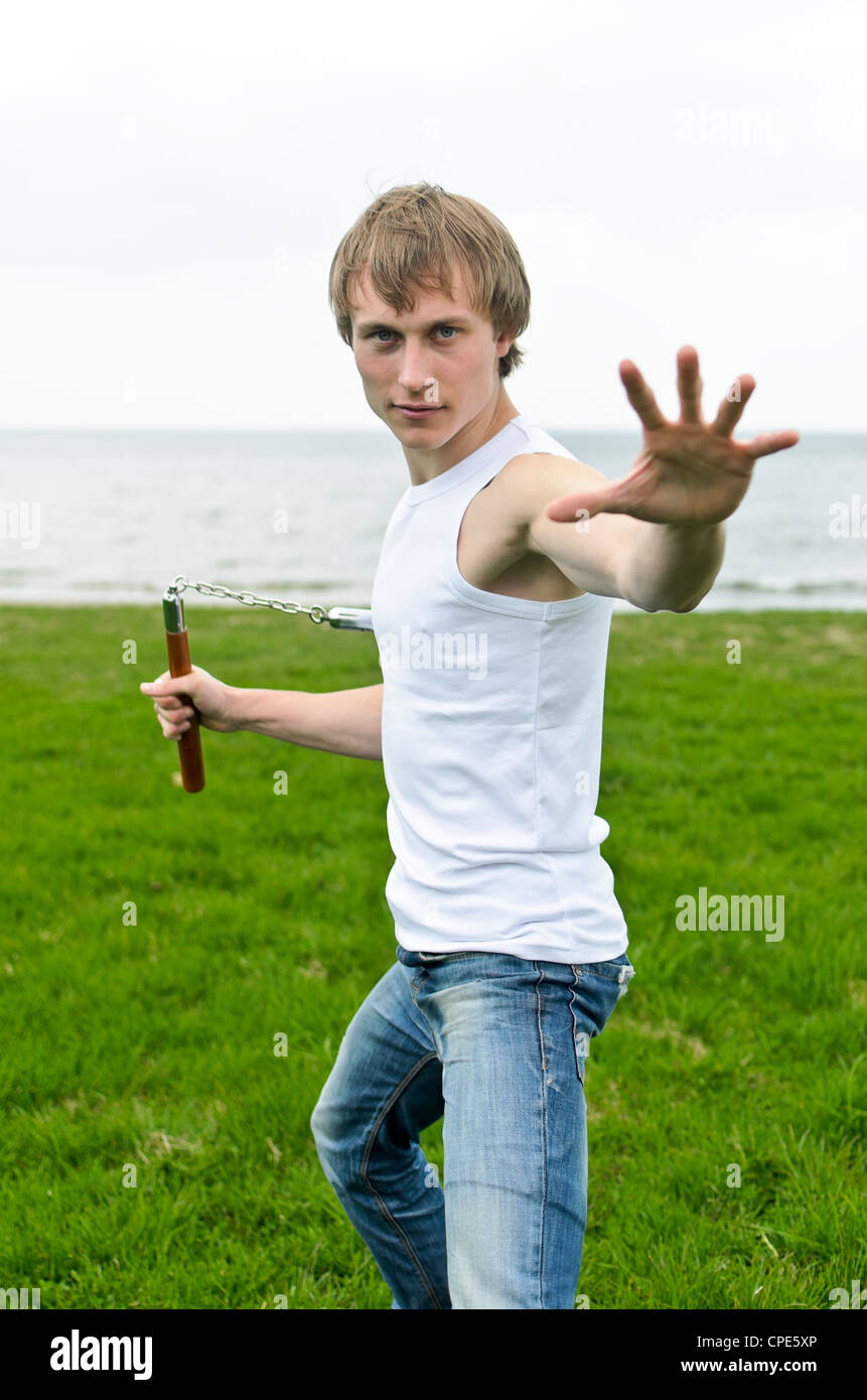 Martial arts: Man with nunchaku Stock Photo - Alamy