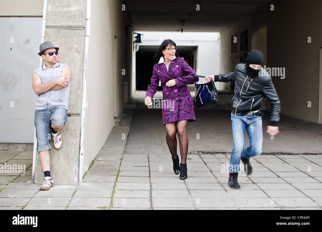 Daylight robbery on the street. Thief steals a bag Stock Photo - Alamy
