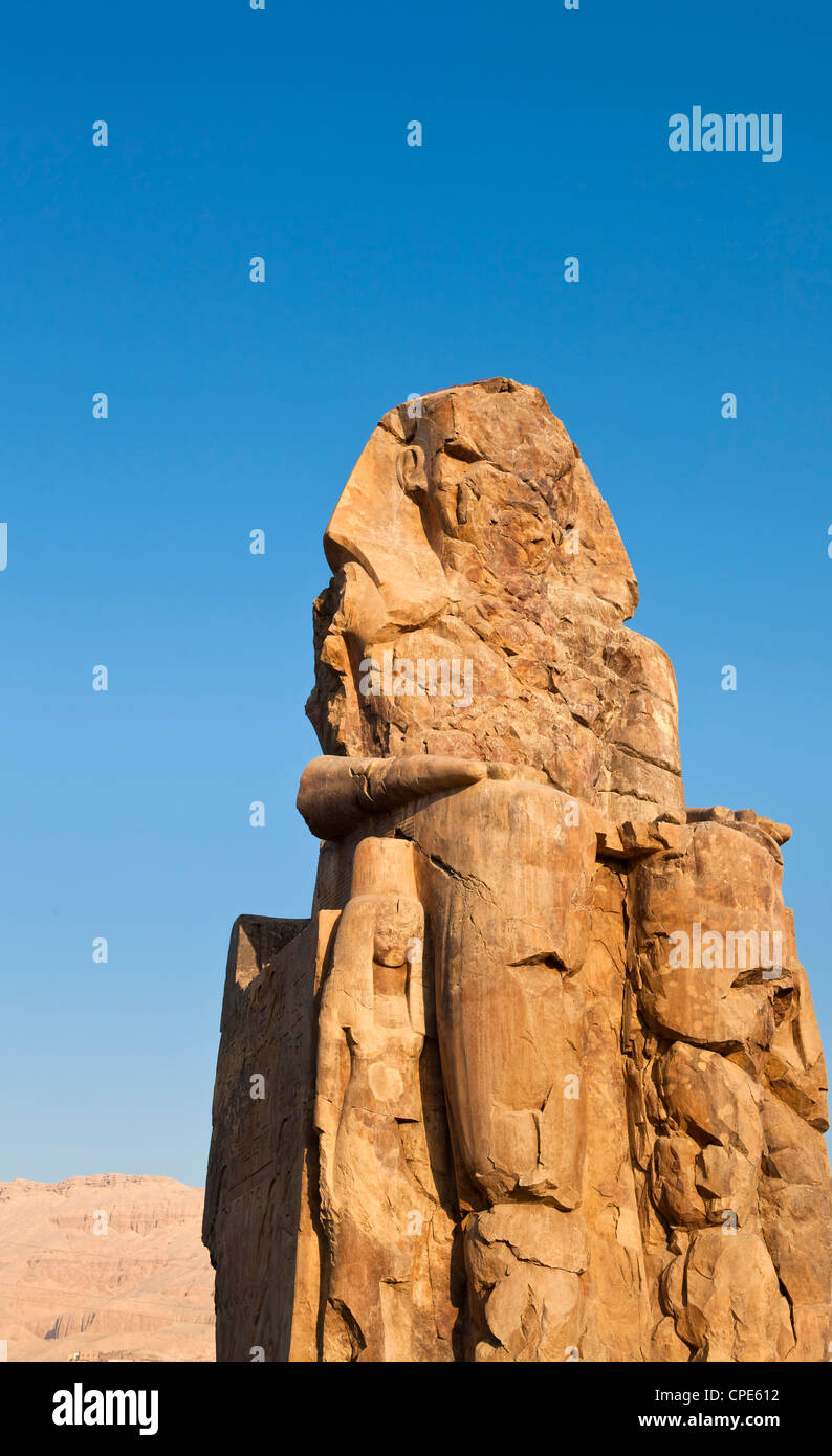 One of the Colossi of Memnon with the Theban hills behind, Thebes ...