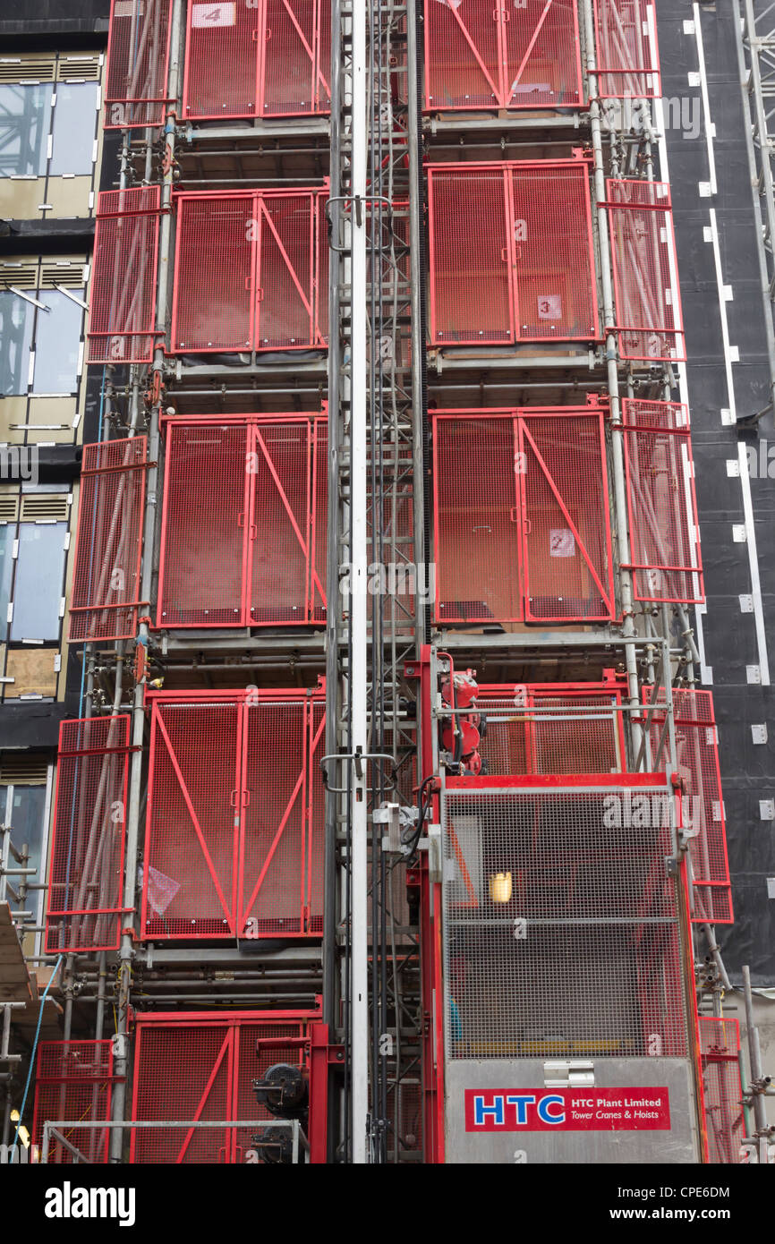 Temporary construction industry hoists on the exterior of the ...