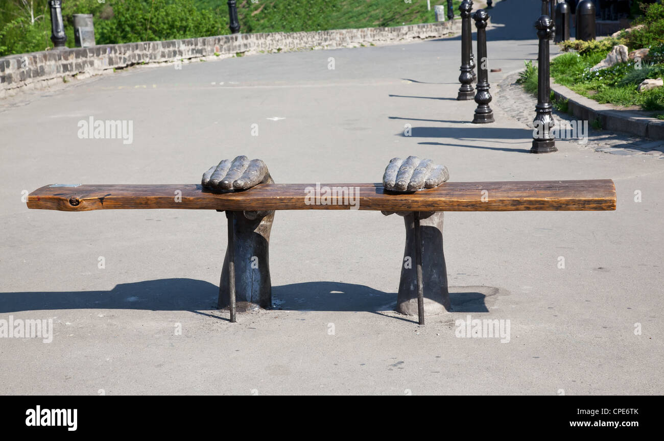 Bench with hands in park Stock Photo - Alamy
