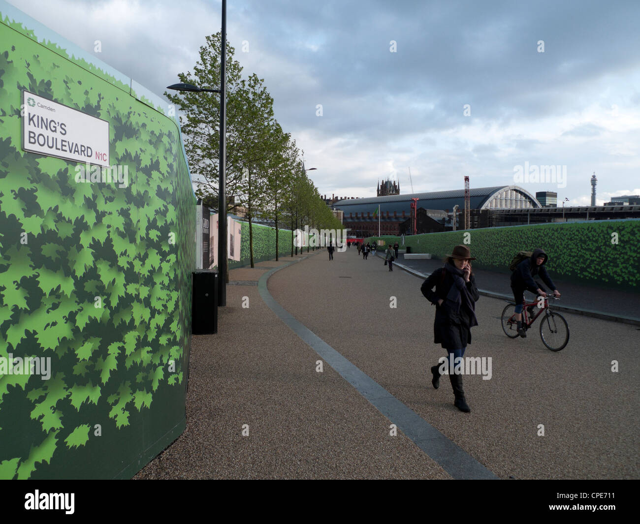 Pedestrians and cyclist and new King's Boulevard walkway sign hoarding ...