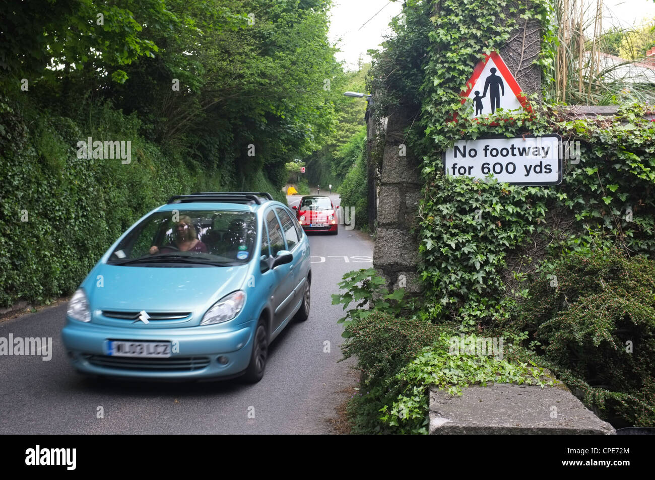 Cars on a narrow road without a pavement for pedestrians Stock Photo ...