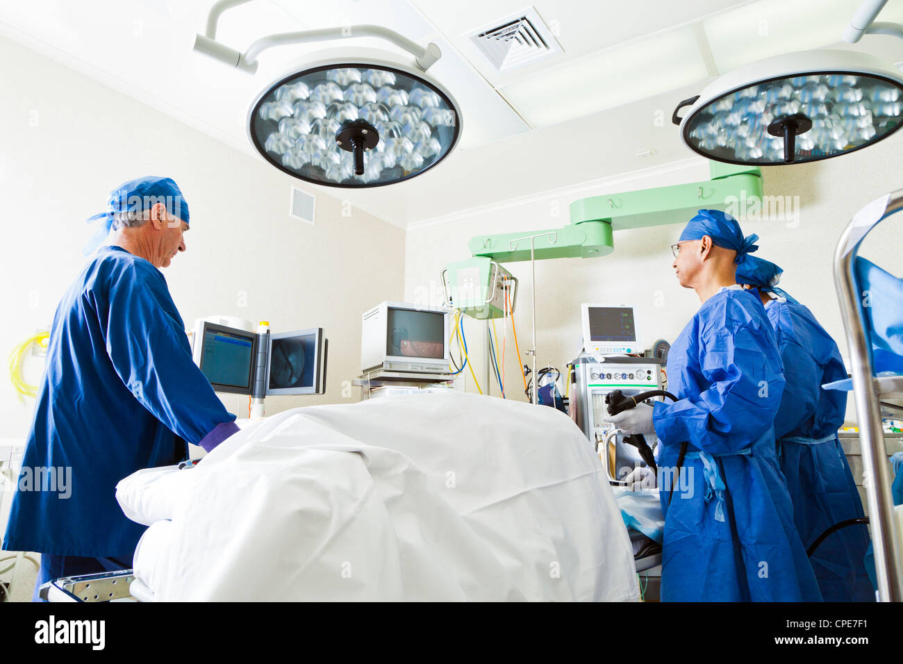 Surgery with operating table, nurses and surgeon Stock Photo - Alamy