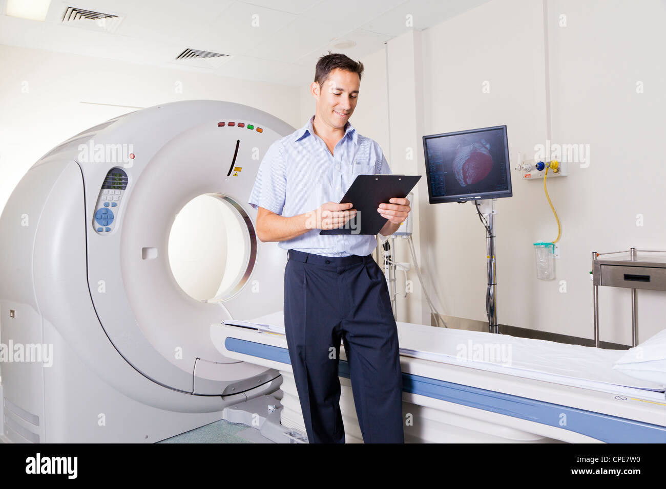 Young doctor standing in front of an MRI scanner Stock Photo - Alamy
