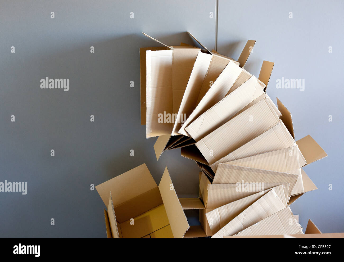 carton open boxes stacked on curved circle shape on gray wall Stock ...