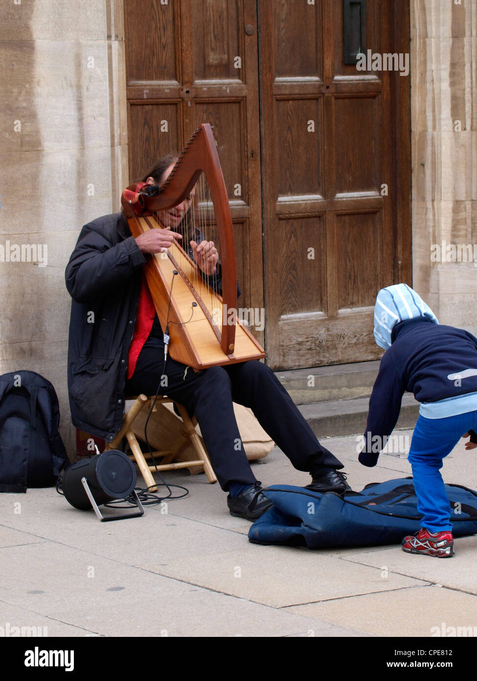 Busker playing a harp, Cambridge, UK Stock Photo - Alamy