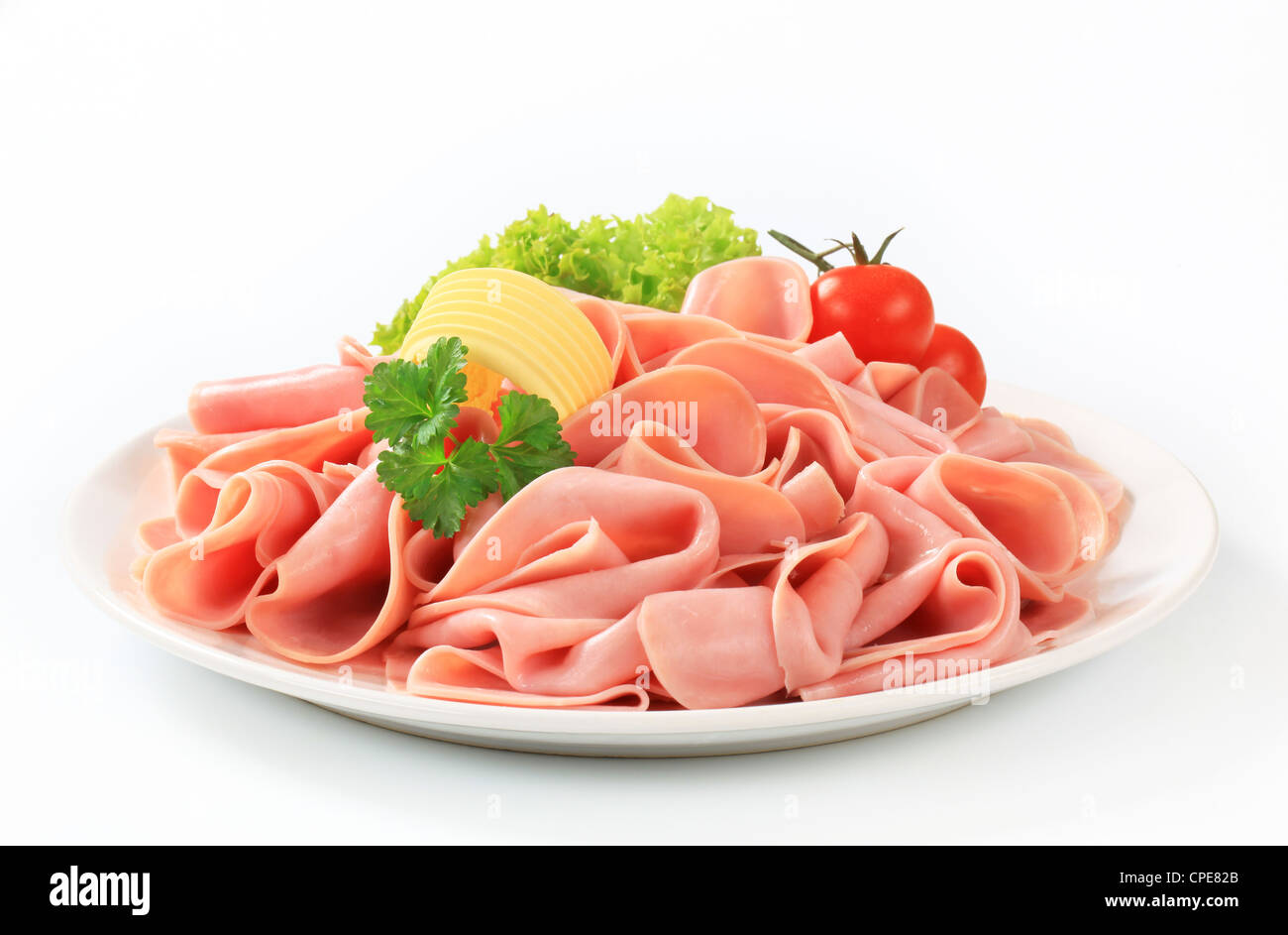 Thinly sliced ham arranged on a plate Stock Photo - Alamy