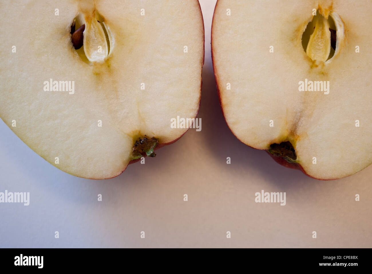 Eating apple cut open showing colour of flesh on white background Stock ...