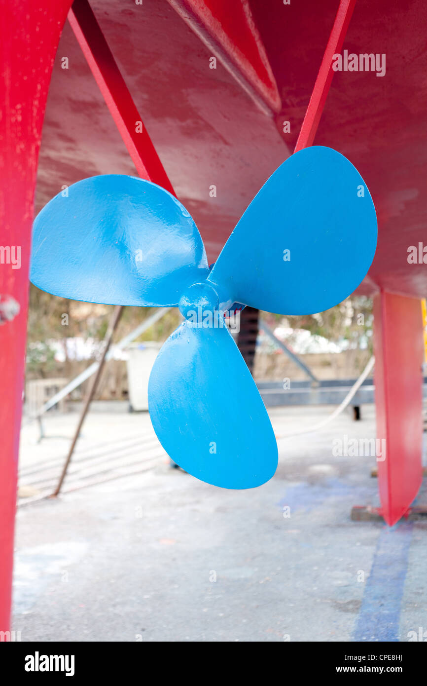 blue sailboat propeller in a red painted hull Stock Photo - Alamy