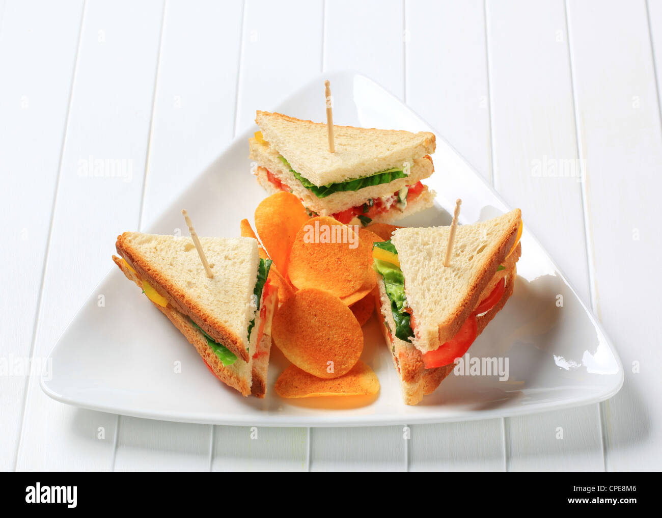 Vegetable sandwich triangles and spicy crisps Stock Photo - Alamy