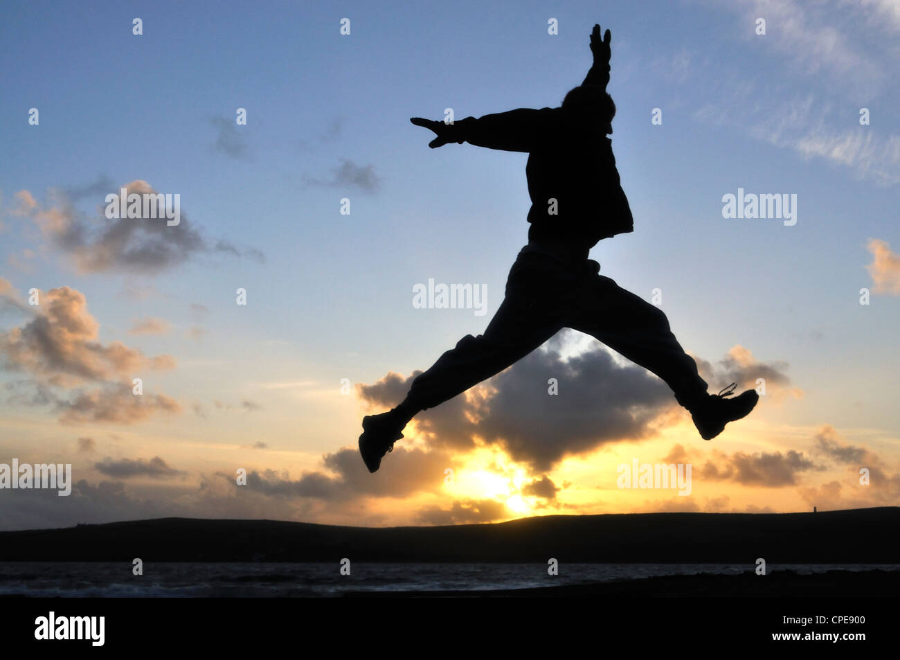 Silhouette of one man jumping over water at the beach Stock Photo - Alamy
