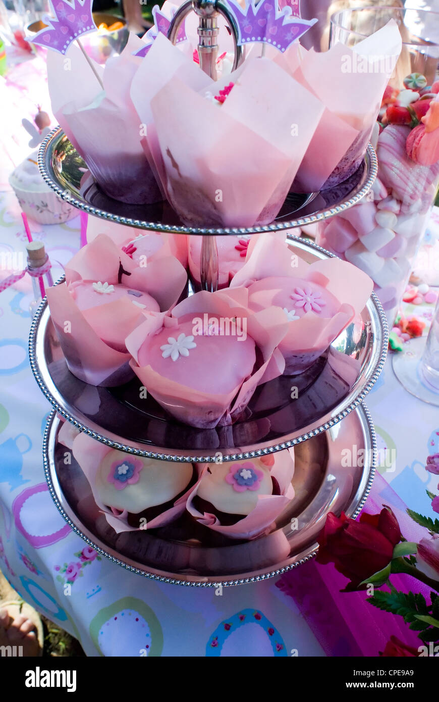 Birthday party pink cupcakes on display tray Stock Photo - Alamy