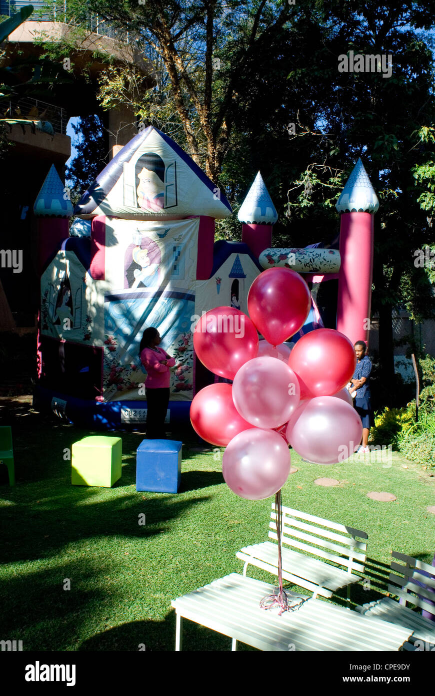 Party Balloons and princess jumping castle Stock Photo - Alamy