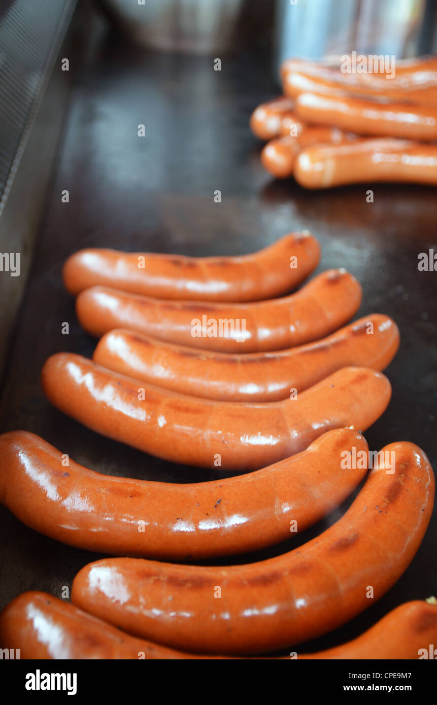 Hot dog sausages cooking on a griddle on a food stall Stock Photo - Alamy