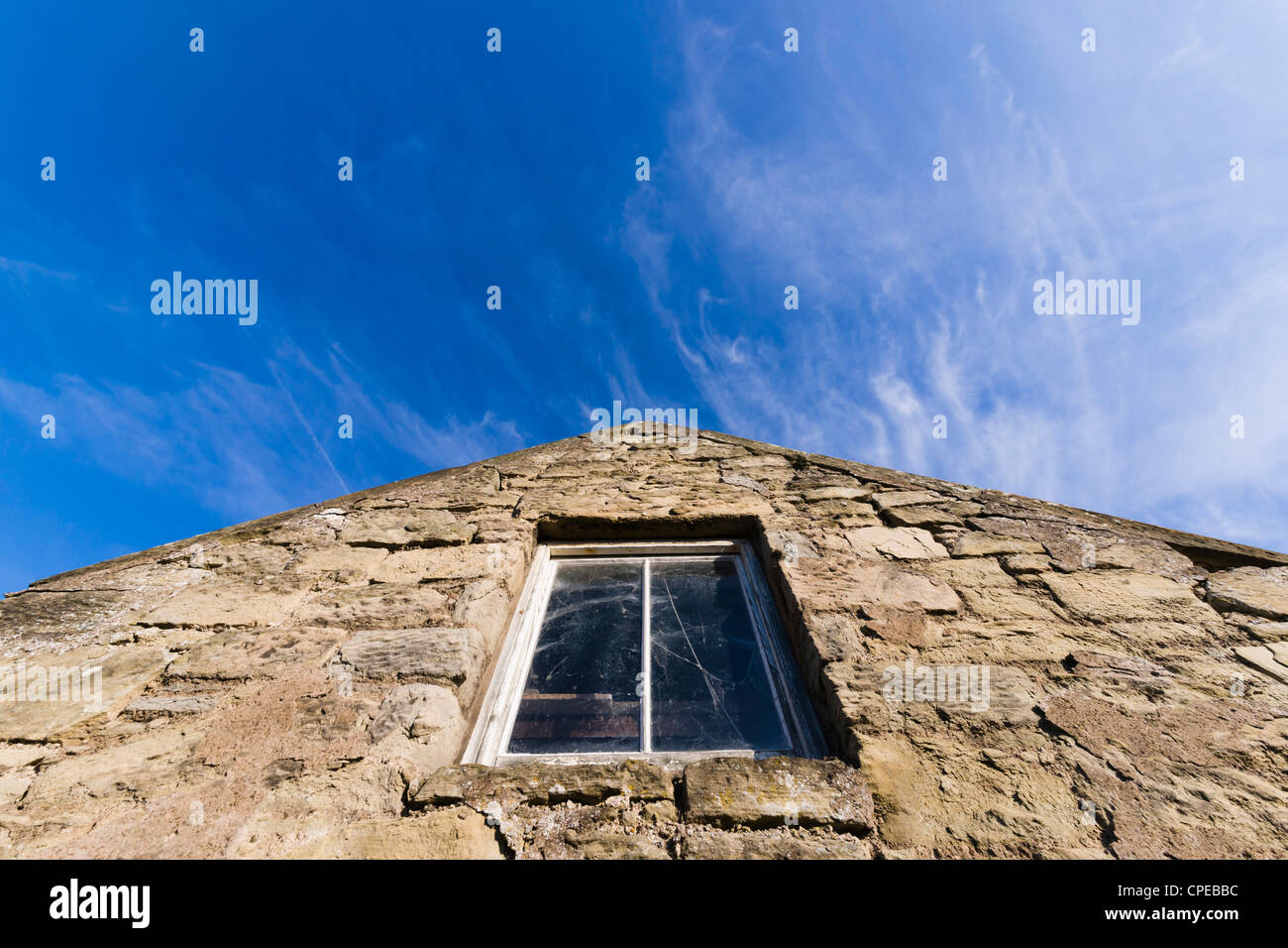 Old stone gable end with window and deep blue sky Stock Photo - Alamy