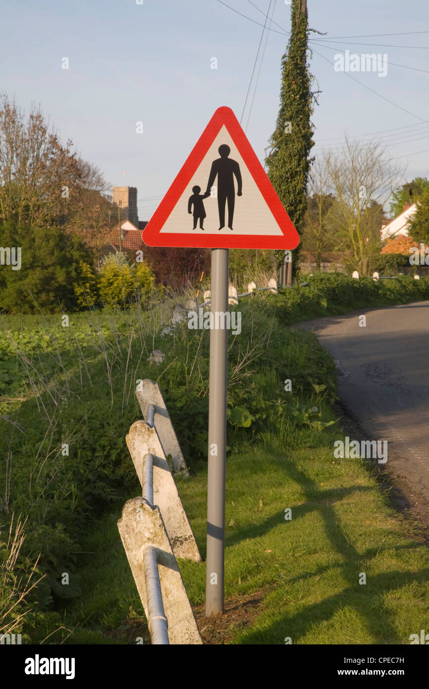 Red triangle road sign adult child holding hands indicating no pavement ...