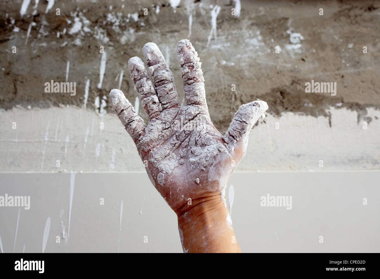 Astist plastering man hand with white dried cracked plaster texture in ...