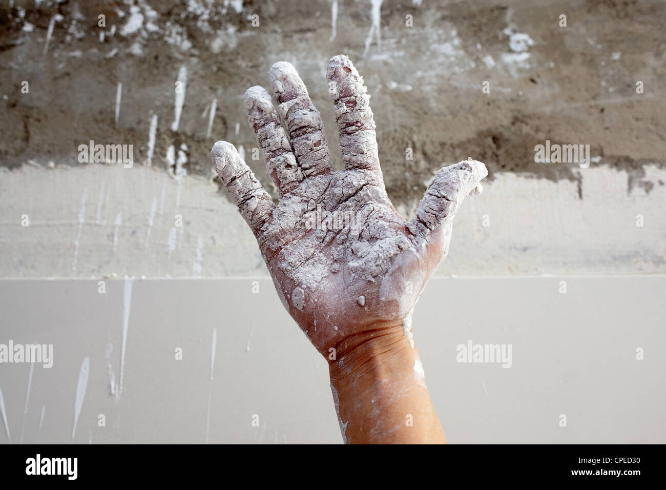 Astist plastering man hand with white dried cracked plaster texture in ...