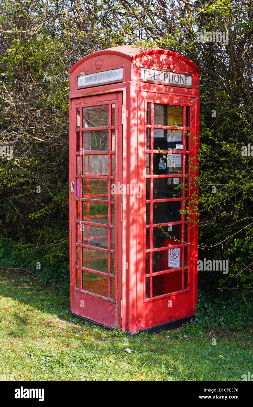 A traditional red telephone box in rural Oxfordshire on a bright spring ...