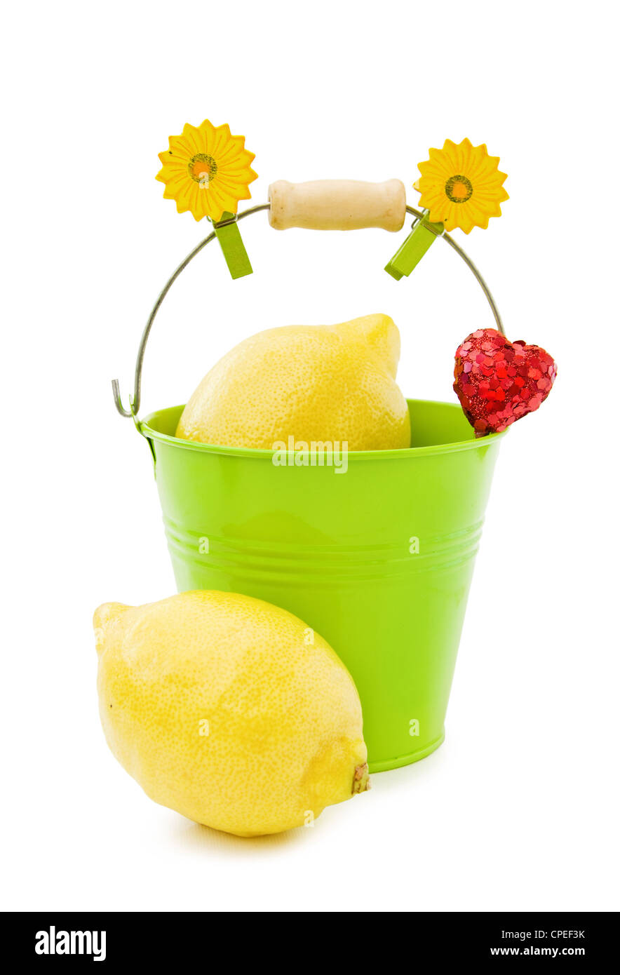 Healthy nutrition - fresh lemons in green garden bucket. Isolated over ...