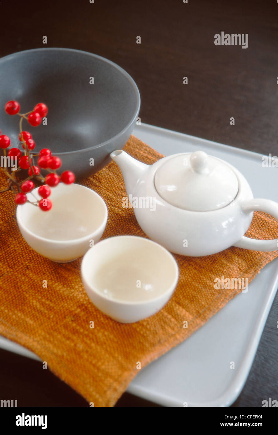 Teacup, Teapot, Bowl And Red Berries In Tray Stock Photo - Alamy