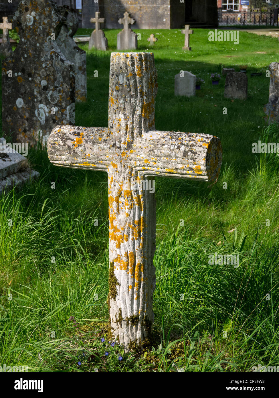 Gravestone in the form of a cross and carved to look as though it is ...