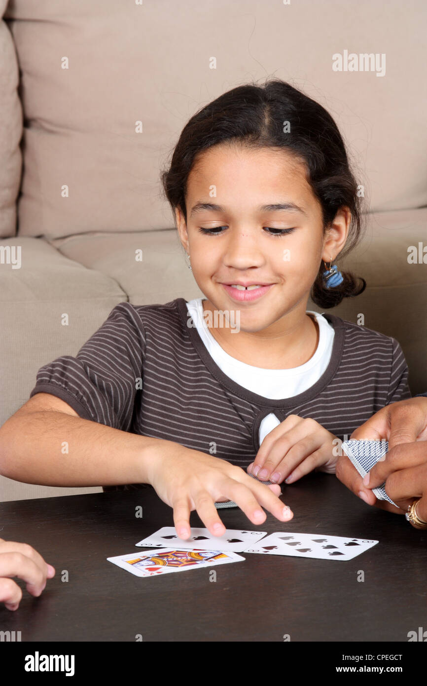 Family playing cards together around the table Stock Photo - Alamy