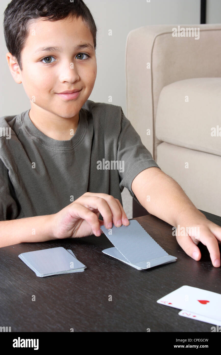 Family playing cards together around the table Stock Photo - Alamy